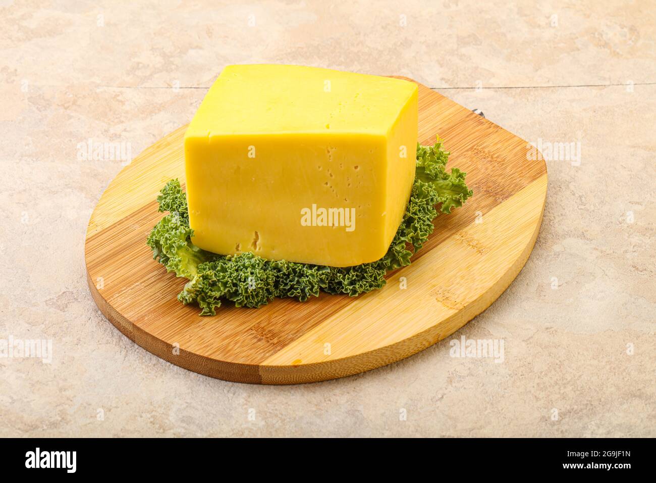 Yellow tilsiter cheese dairy product brick Stock Photo - Alamy