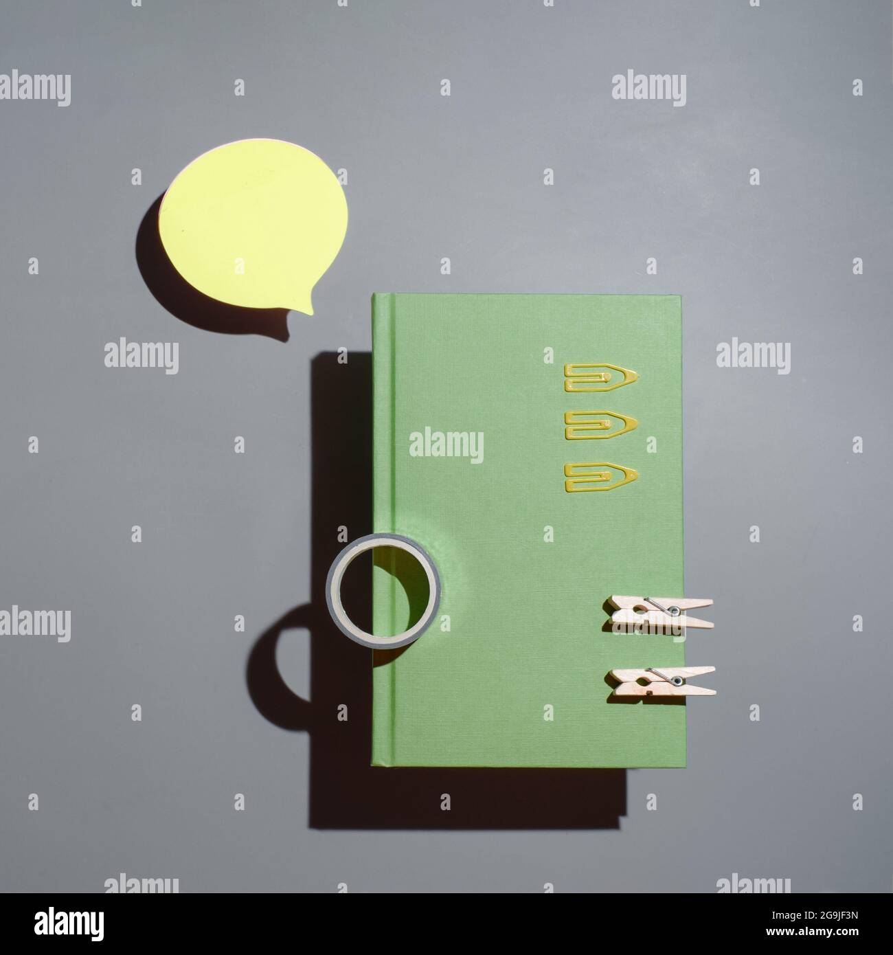 Notepad, yellow sticker and office supplies on the blue background ...