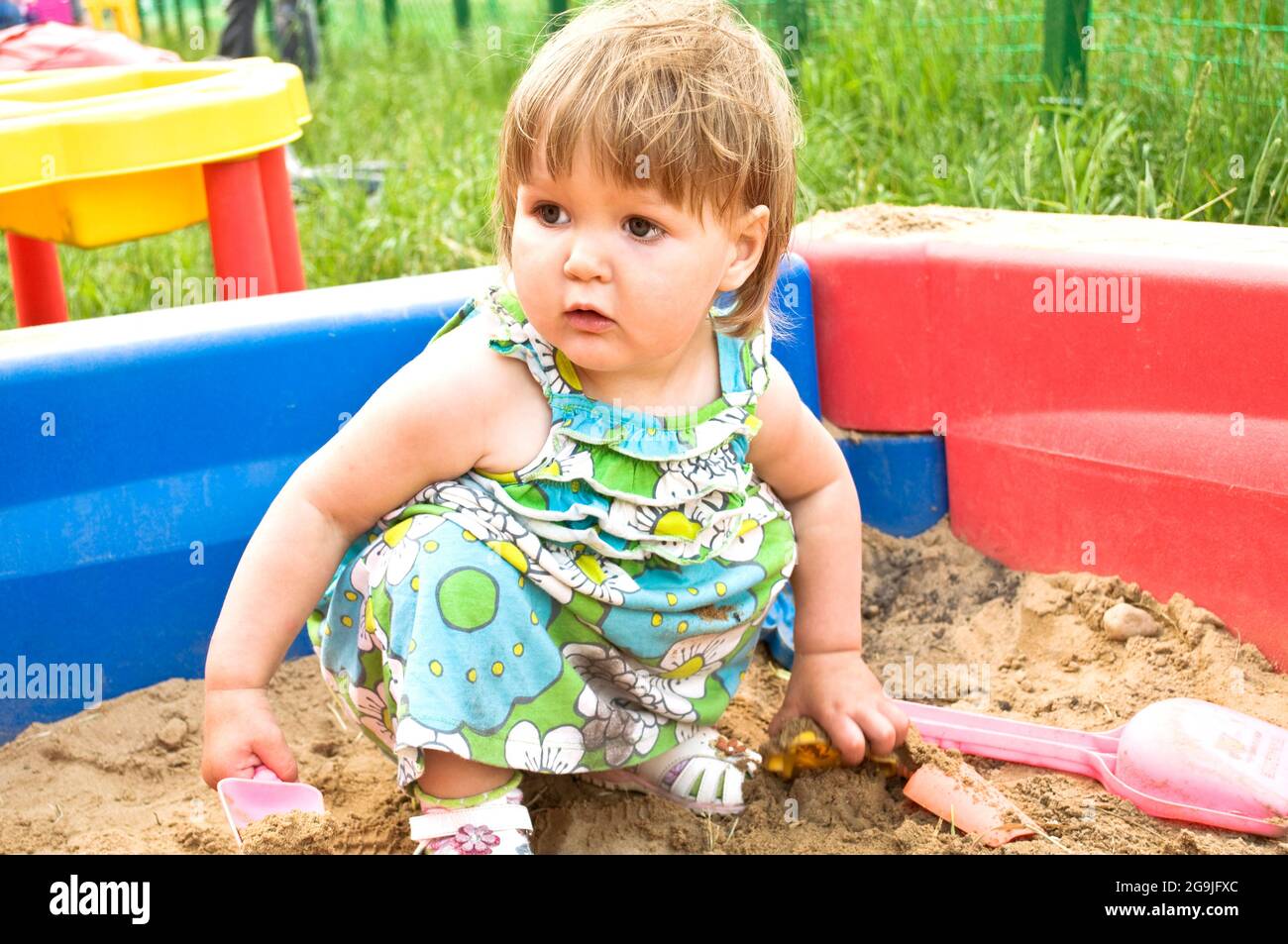 Little girl playing in the sandbox Stock Photo - Alamy