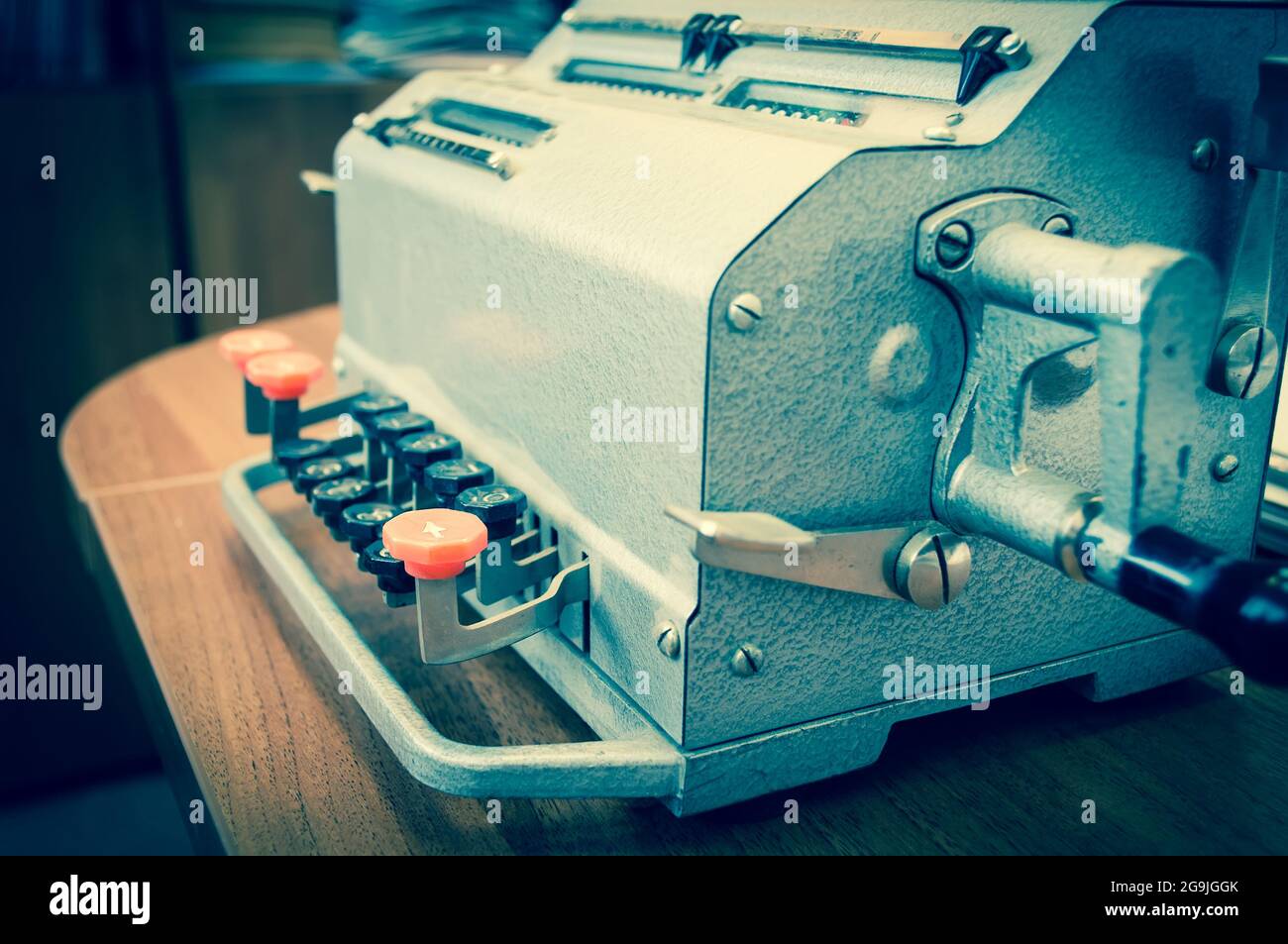 Vintage mechanical adding machine on table Stock Photo - Alamy