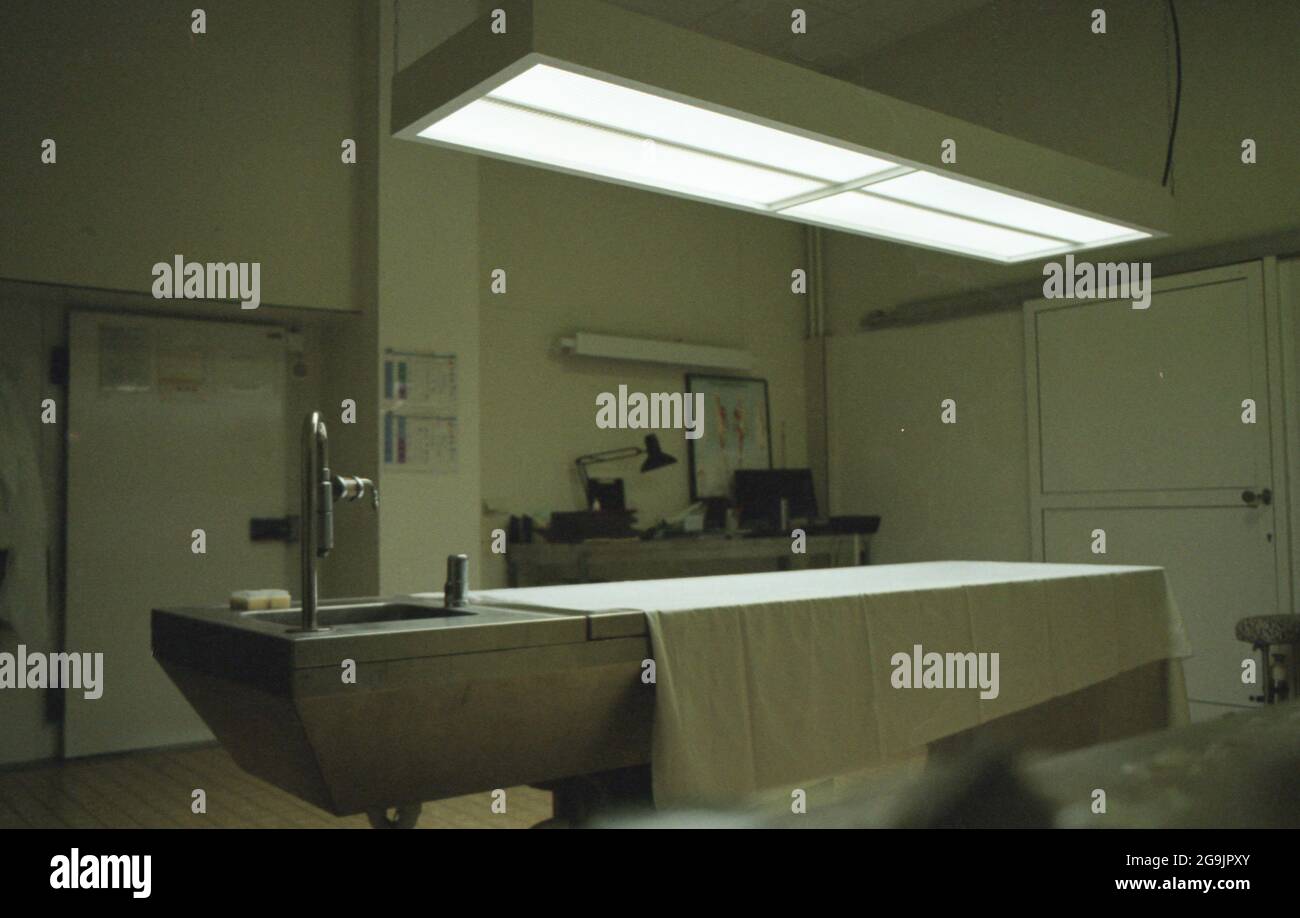 Examination table for hospitals with a tap under the lights in a dark ...
