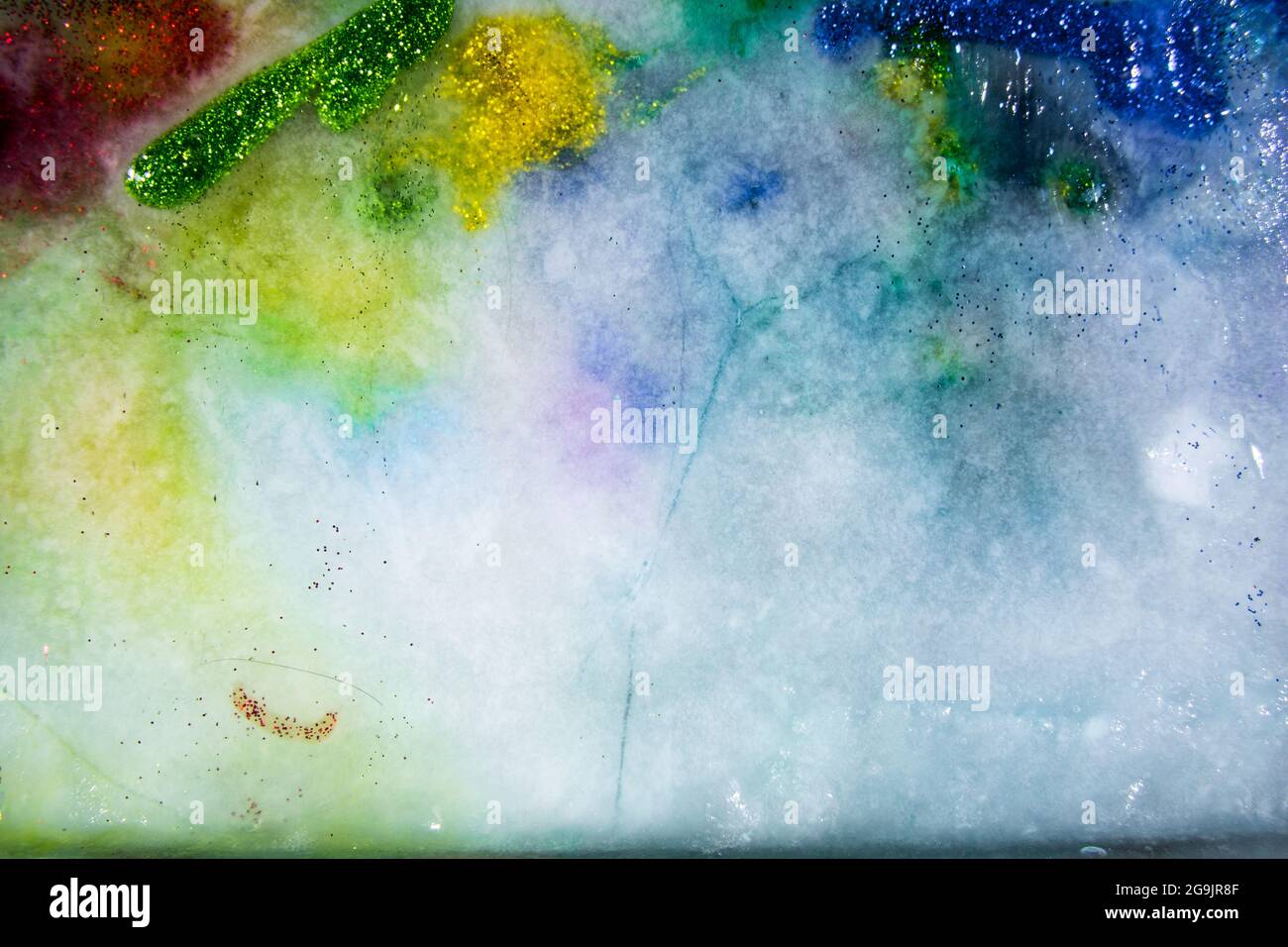 Colored ice with glitter, melting. Glitter and colors! Transparent and ...