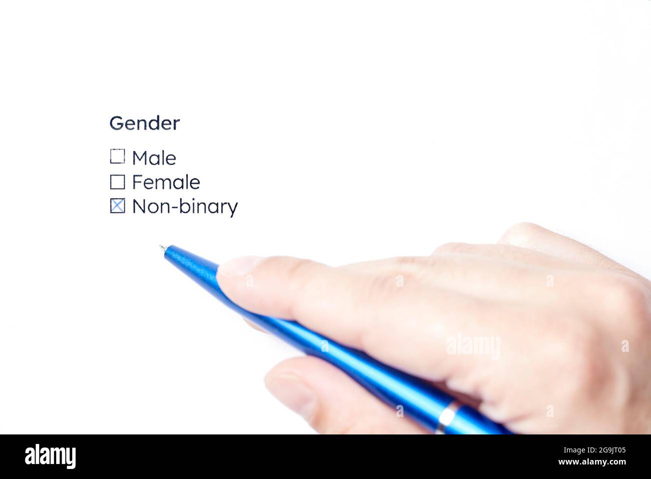 Hand of unrecognizable person marking the non-binary option on a form ...