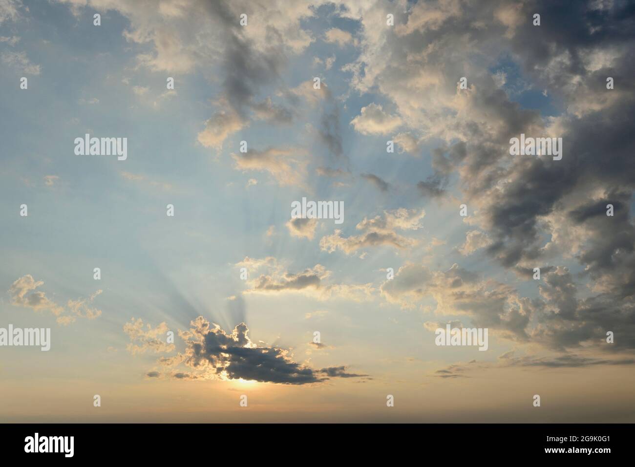 Morning sun hidden by cumulus clouds, ray fan, sunrise, North Rhine ...