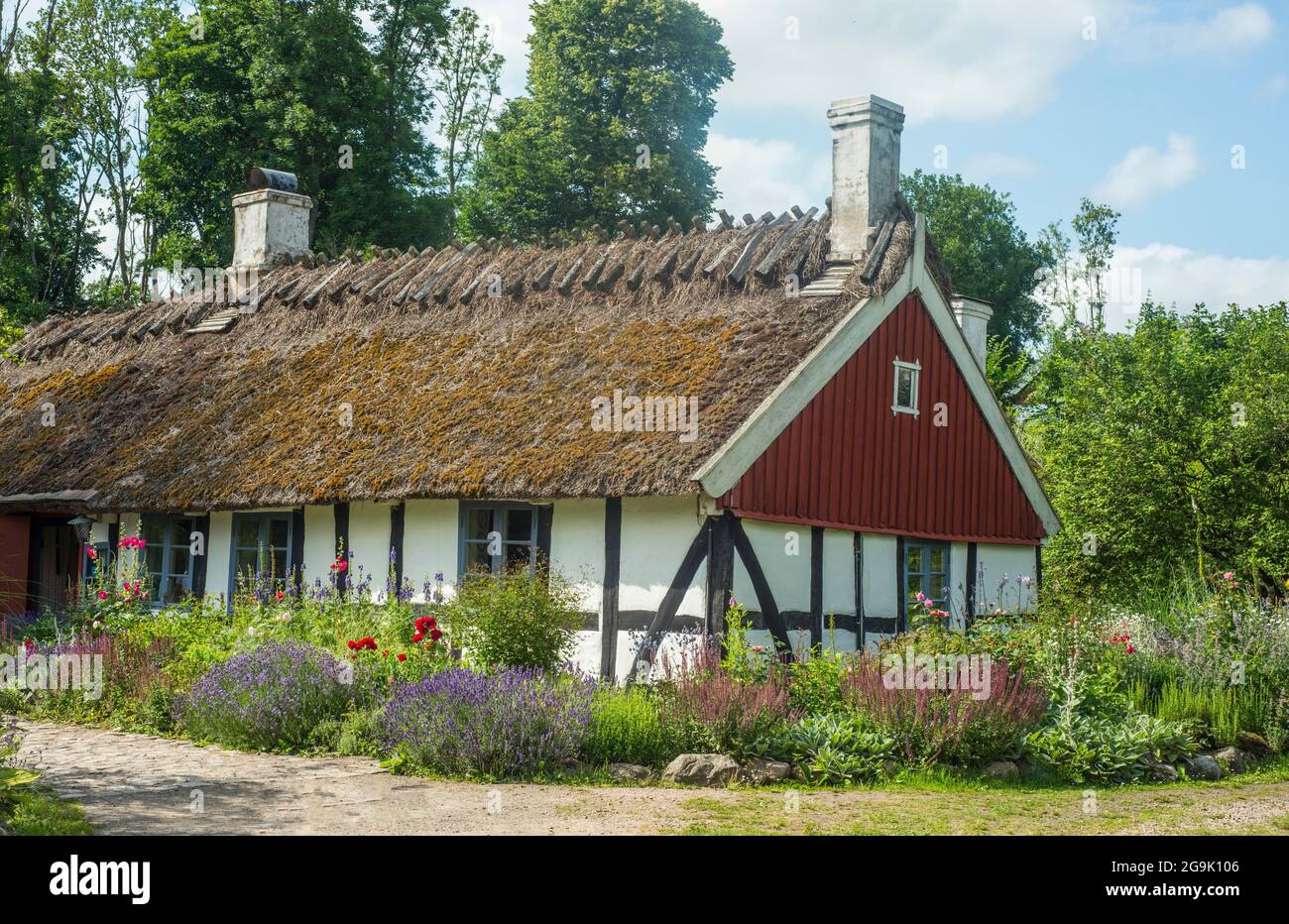 Old typical cottage with half timbered walls and thatched roof in ...
