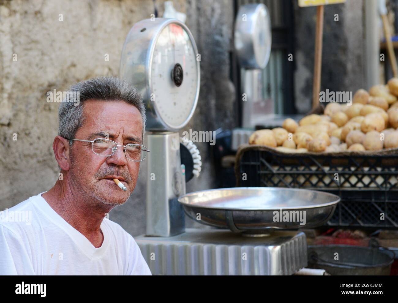 An Italian man smoking a cigareete at the vibrant Antignano market in ...