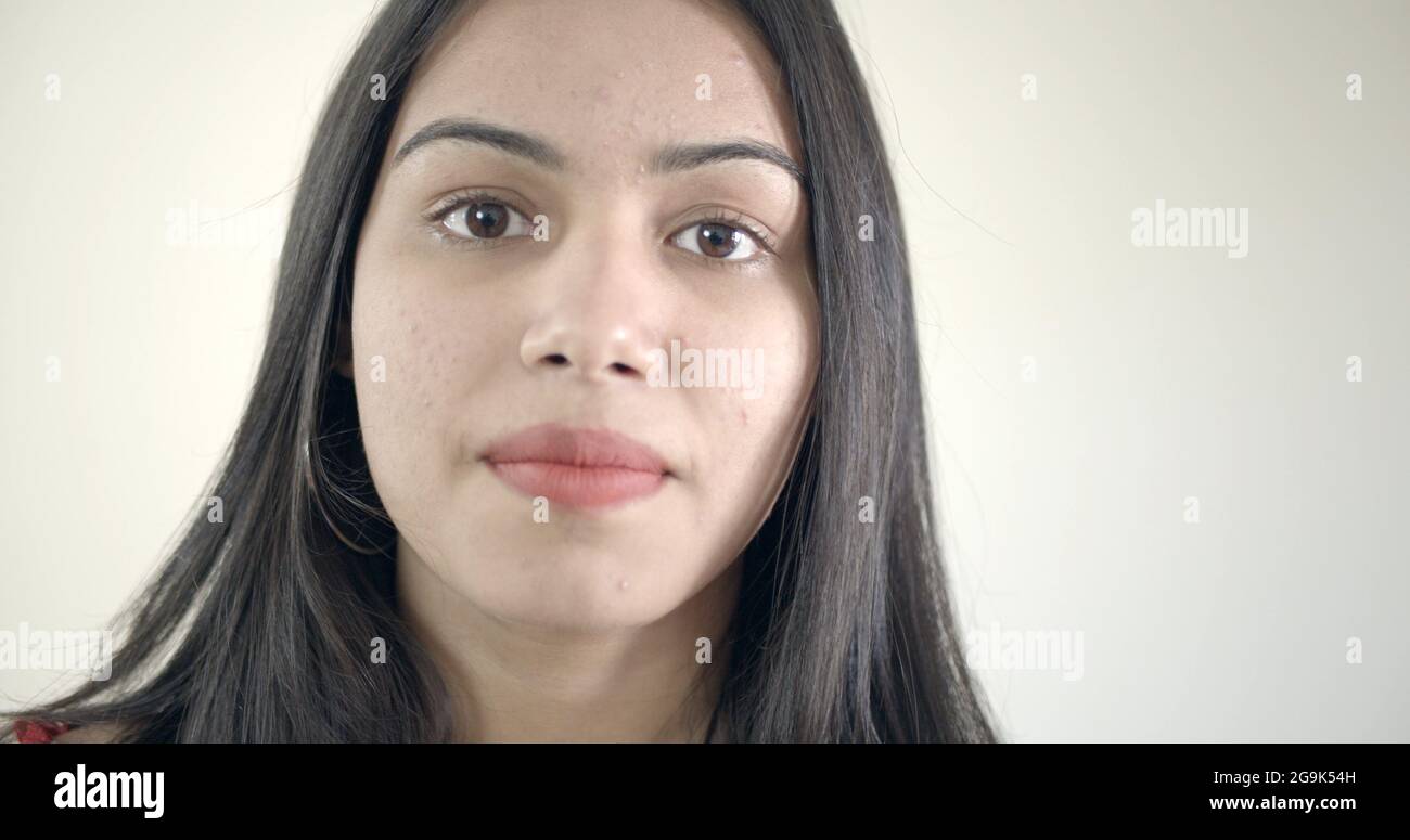 Attractive South Asian female's face on a white wall background Stock ...