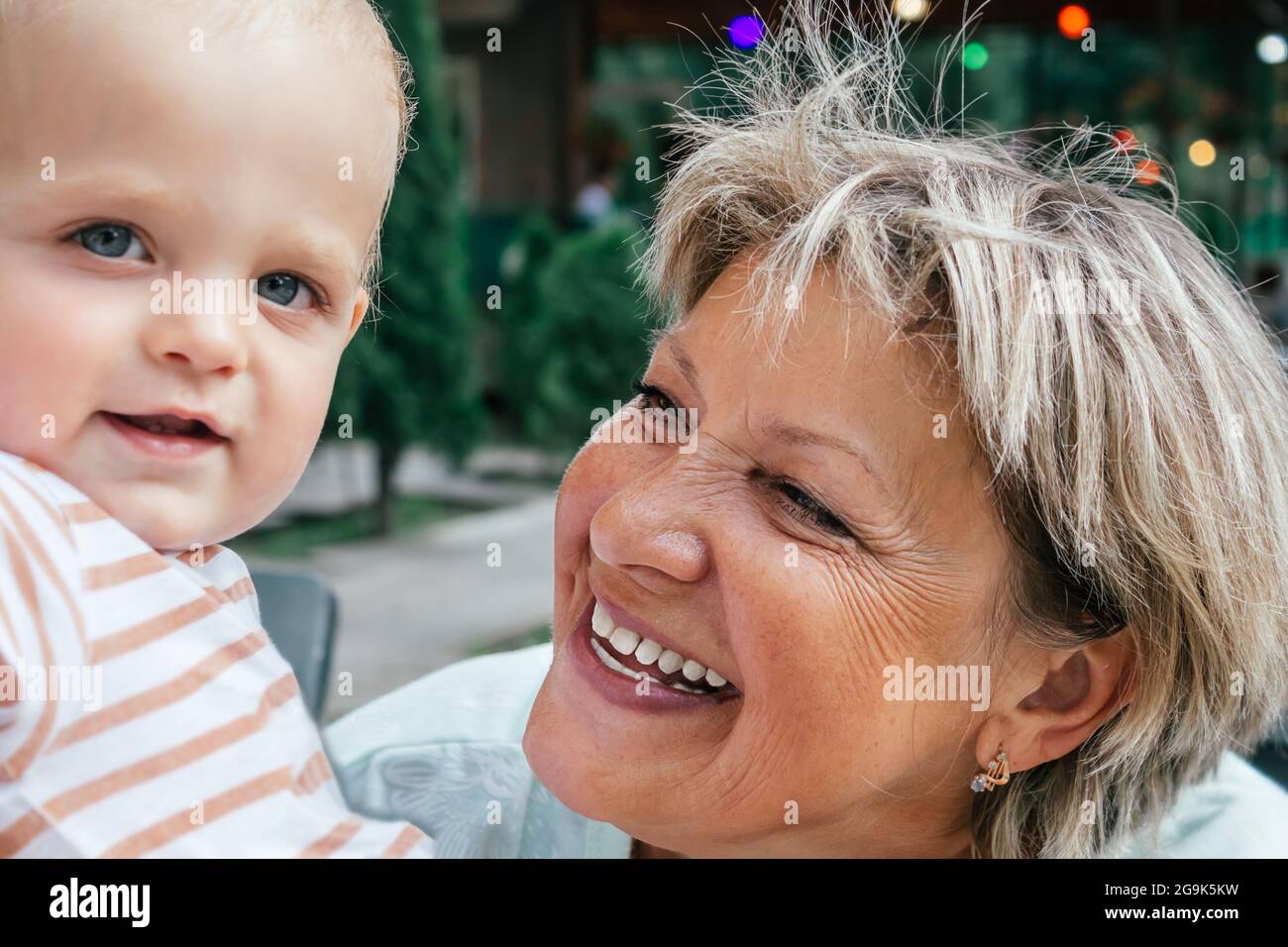 Grandma laughs and takes selfies with grandson Stock Photo - Alamy