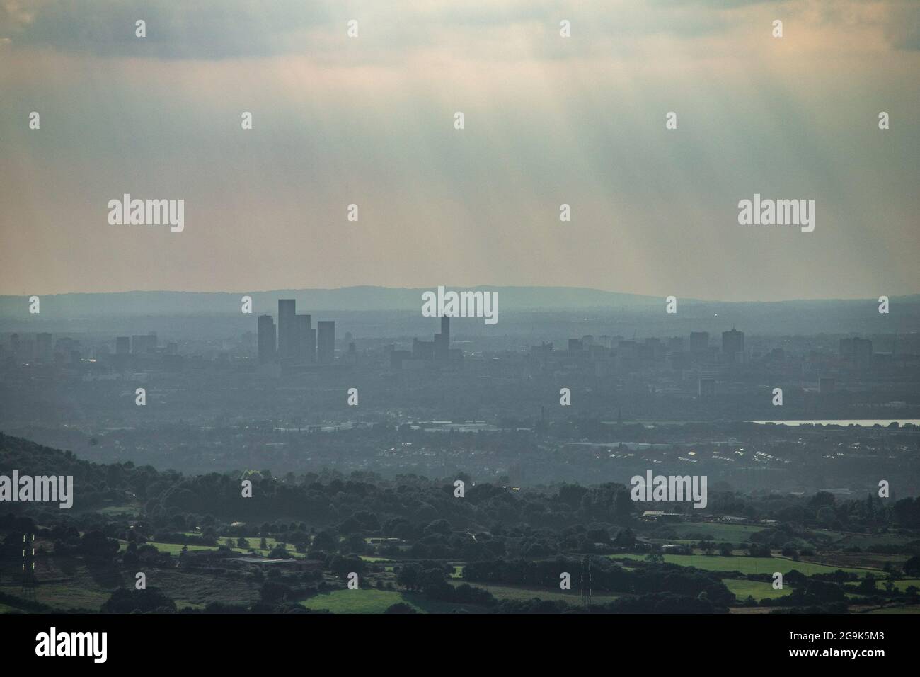 Manchester, UK. 25th July, 2021. Sun rays beam over Manchester as the ...