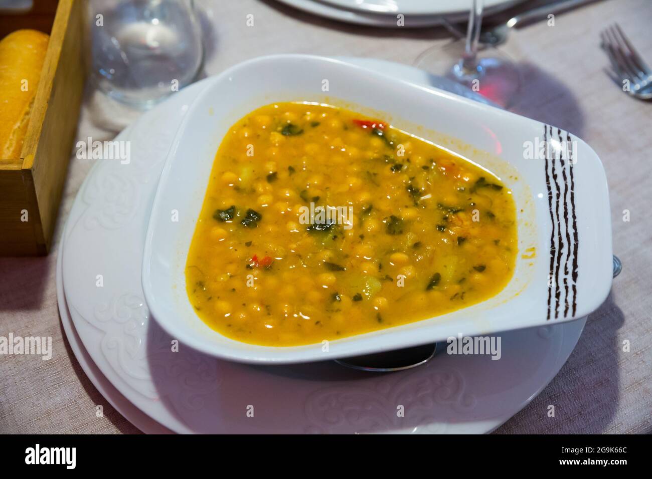 Garbanzo bean soup on a white plate Stock Photo - Alamy