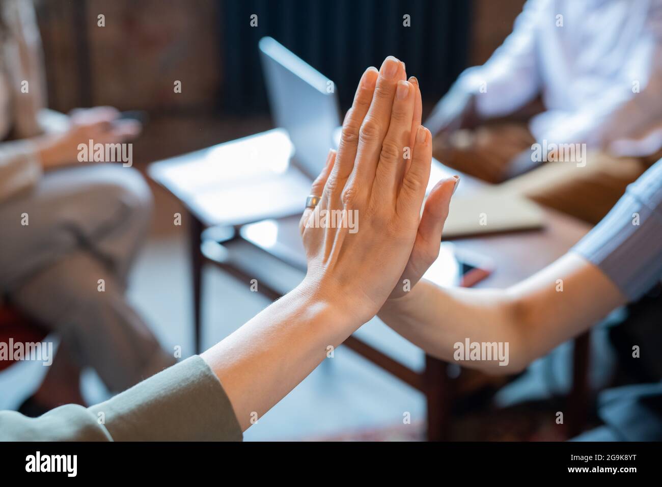 Two businesswomen making high-five gesture in working environment Stock ...