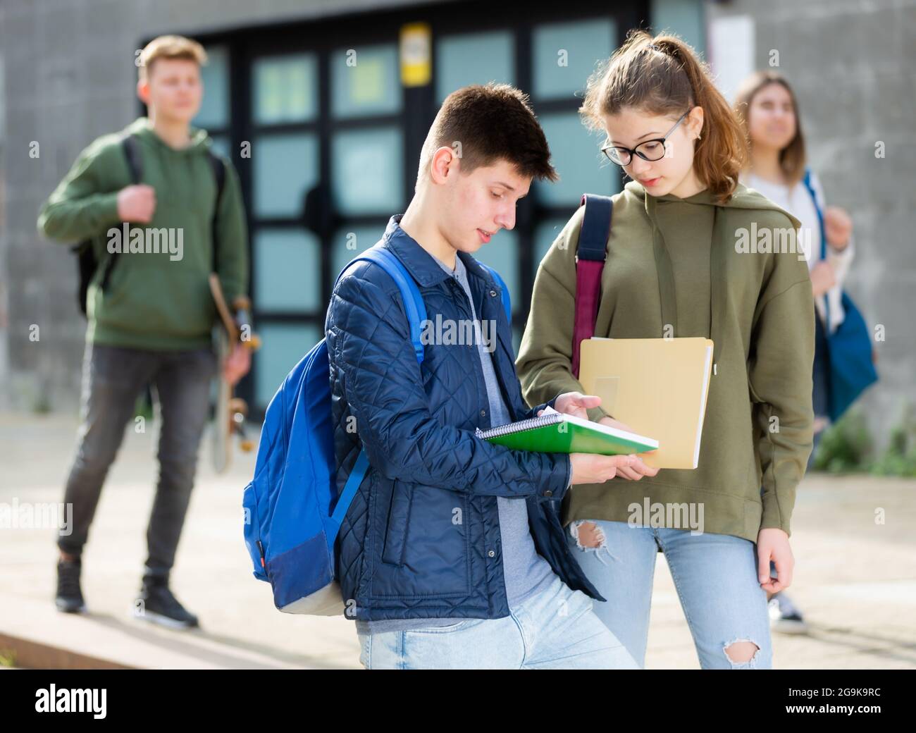 Teenage girl and boy talking outside Stock Photo - Alamy