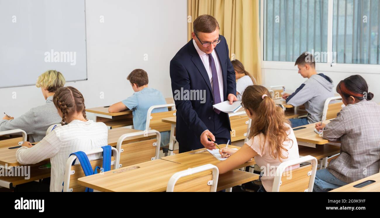 Teacher explains to the students the subject of instruction in ...