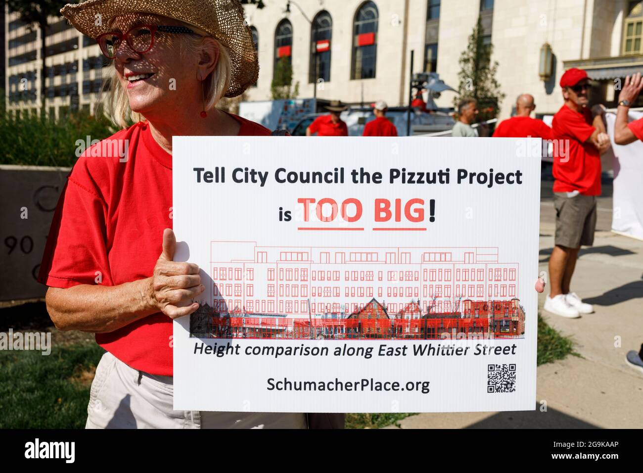 Community member holds a placard to oppose development of their neighborhood by The Pizzuti ...