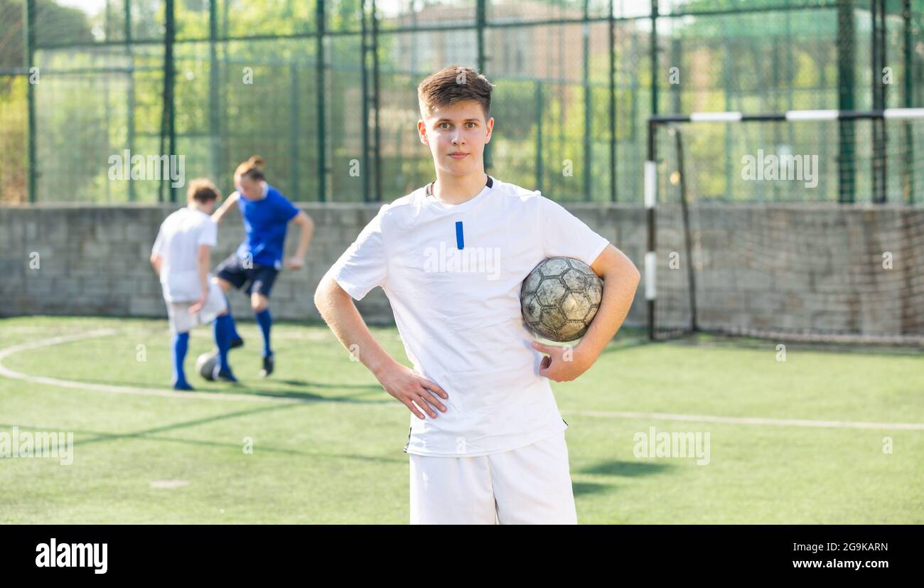 Boy standing on lawn football hi-res stock photography and images - Alamy