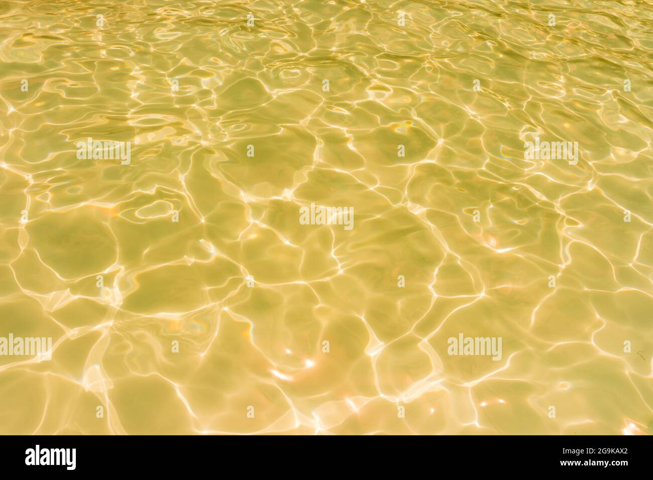 Gold swimming pool rippled water texture reflection Stock Photo - Alamy