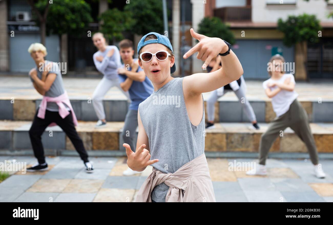 Happy positive teenagers learn dance movements at street Stock Photo ...