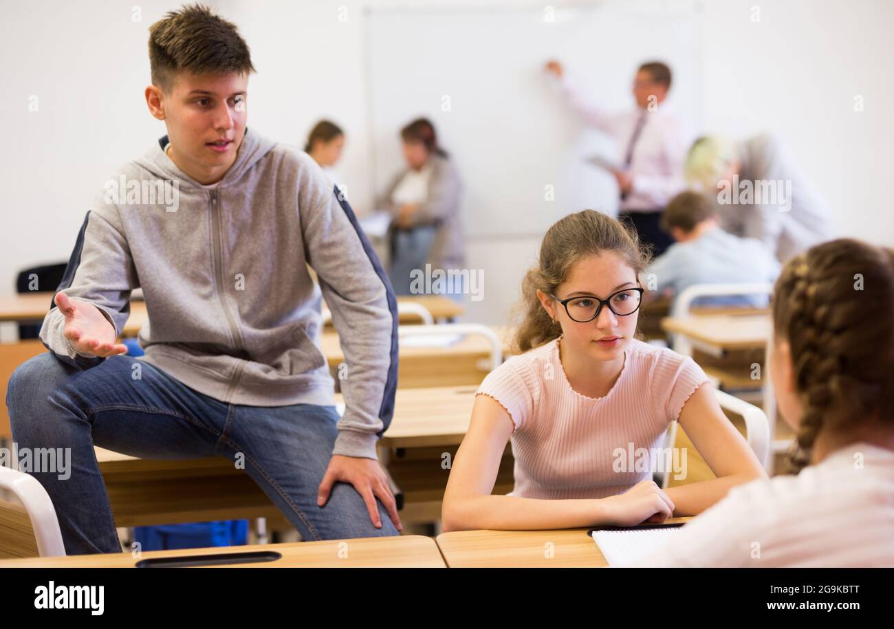 Teenage students talking during recess between lessons Stock Photo - Alamy