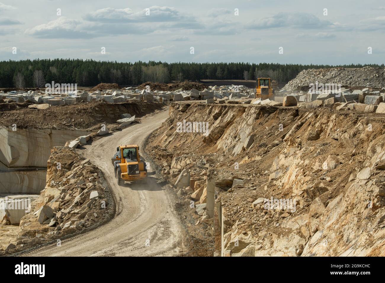 Mining truck moving down road towards building area Stock Photo - Alamy
