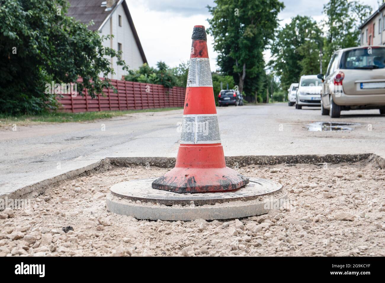 Warning cone with reflectors. Road repair and sewerage well Stock Photo ...