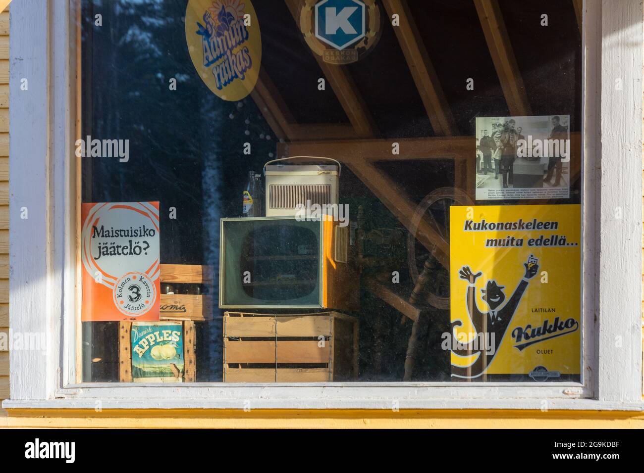 Old countryside shop window with vintage goods behind a dusty window ...