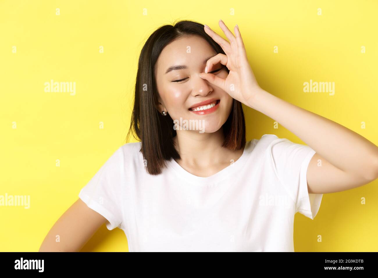 Close up of cute asian girl feeling happy, showing OK sign on eye and ...