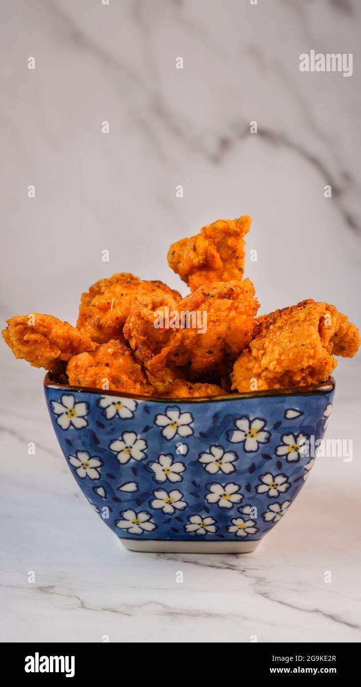 Spicy deep fried chicken tenders strips crunchy in bowl isolated on ...