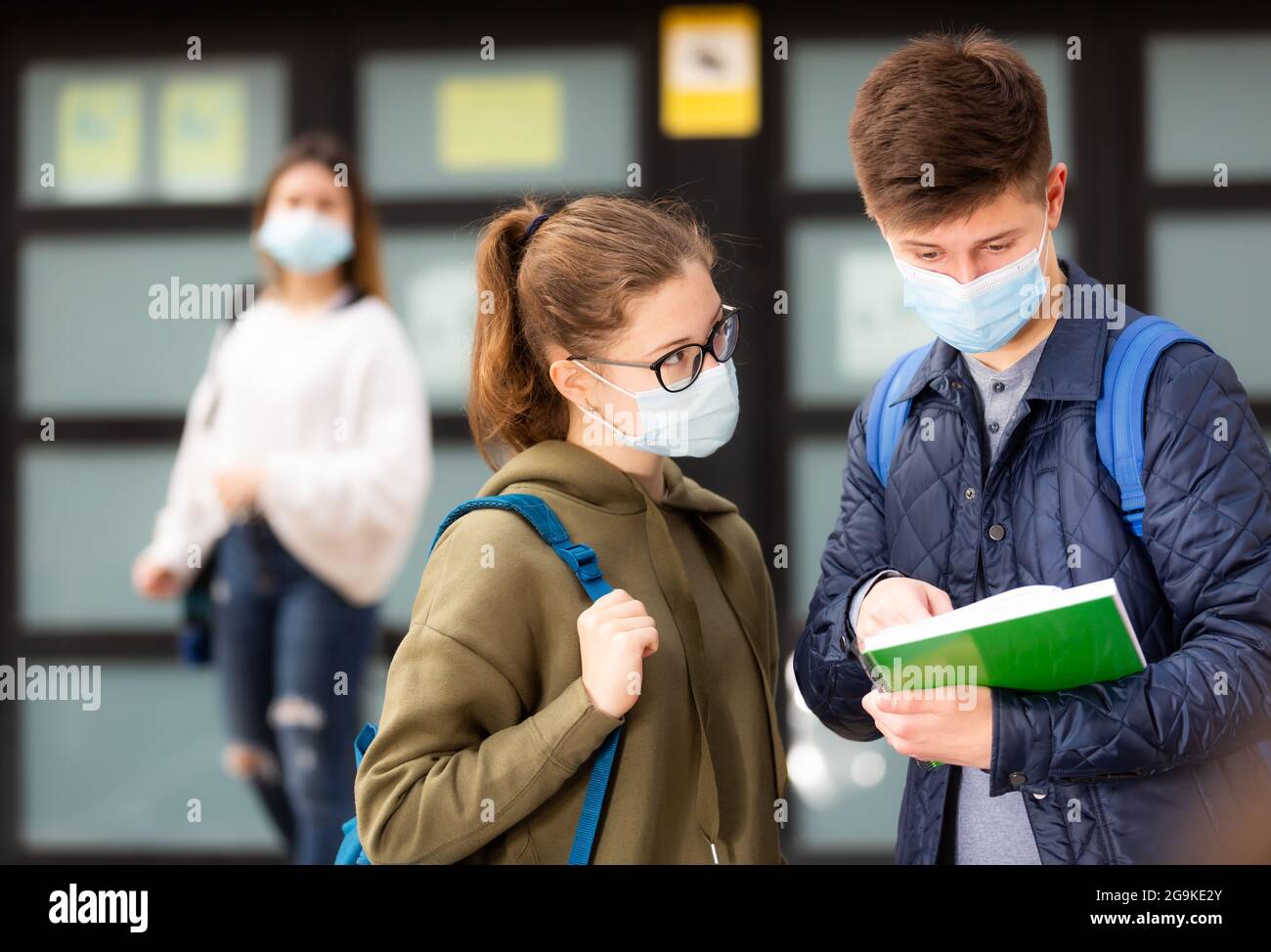 Teenagers in masks friendly talking outside Stock Photo - Alamy