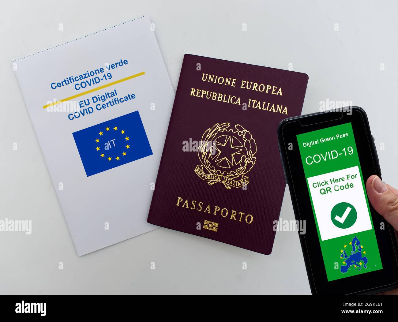 Digital green pass Covid-19 of EU on smartphone held by hand. Italian European Passport and EU ...