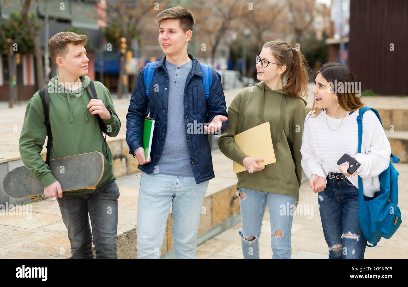 Carefree teen students walking outside school Stock Photo - Alamy