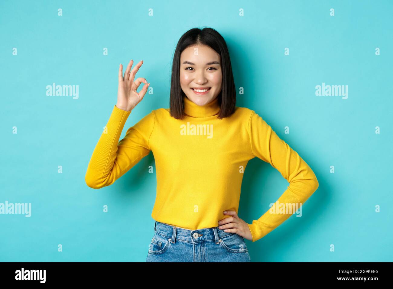 Happy beautiful asian woman smiling, showing okay gesture in approval ...