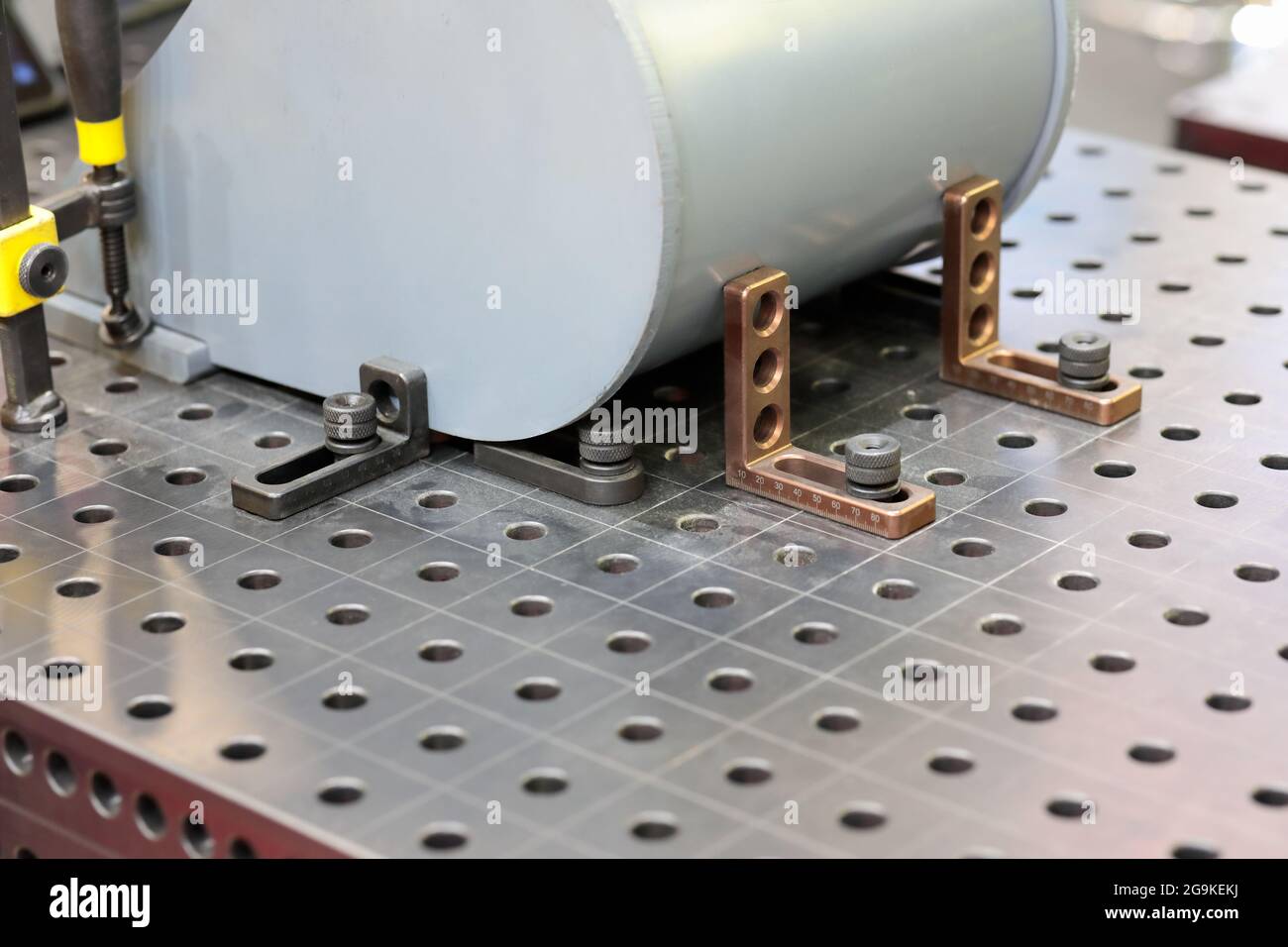 Metal welding table with workpiece mounted by clamps and locating ...