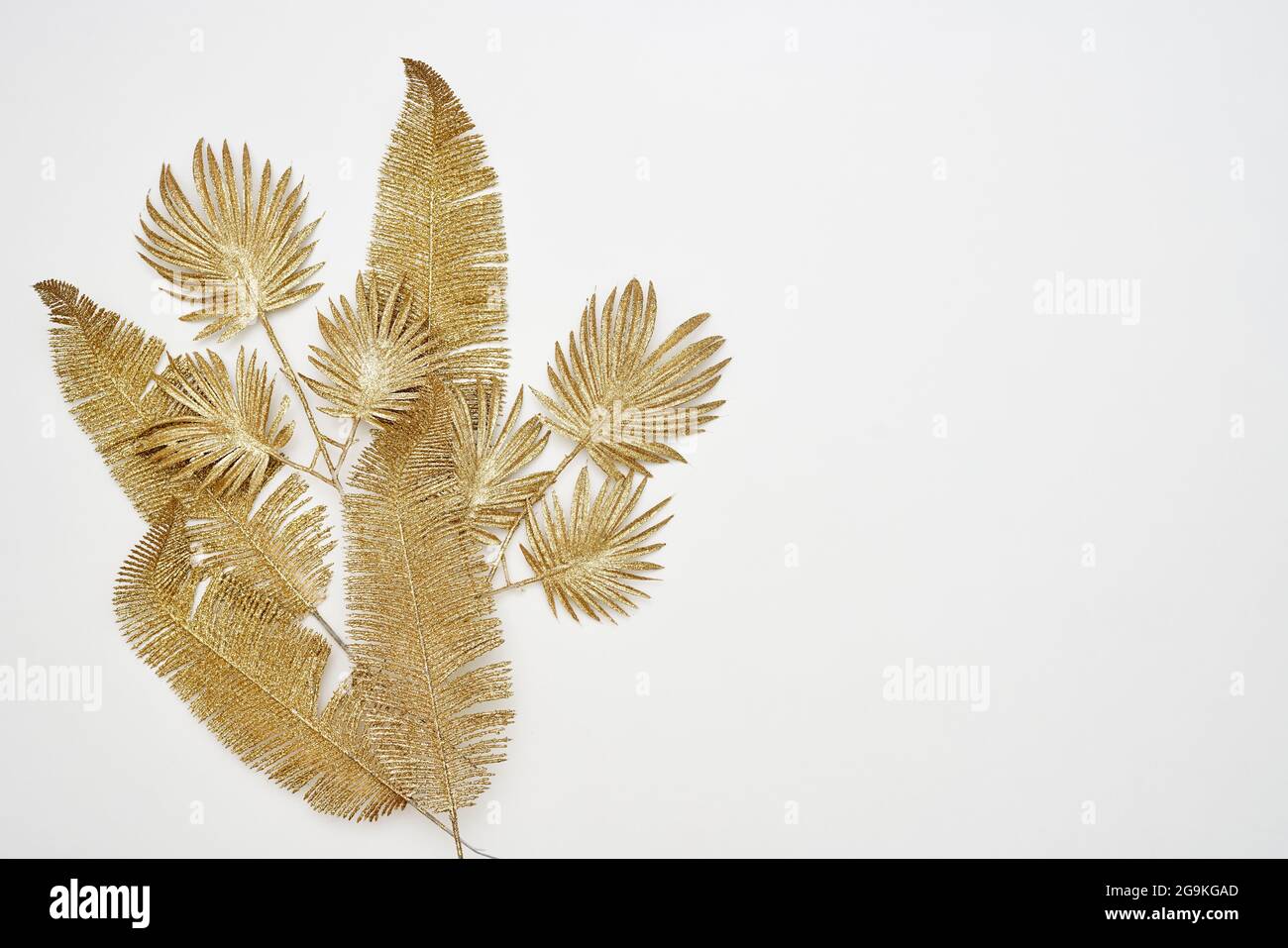 Decorative golden autumn leaves. Fake autumnal leaves on white ...
