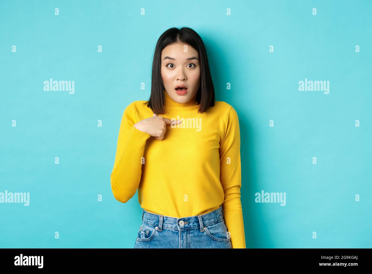 Image of surprised asian girl gasping and pointing at herself with ...
