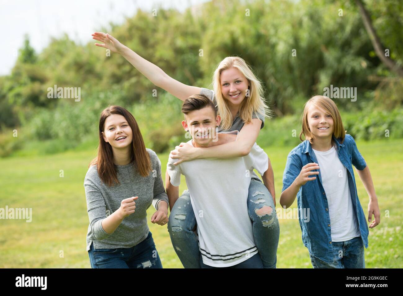 Team of laughing friends having fun and running Stock Photo - Alamy
