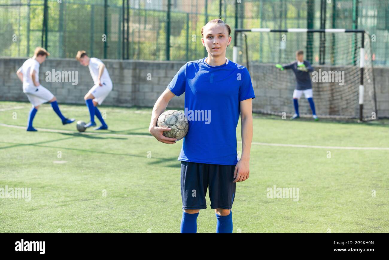 Boy standing on lawn football hi-res stock photography and images - Alamy