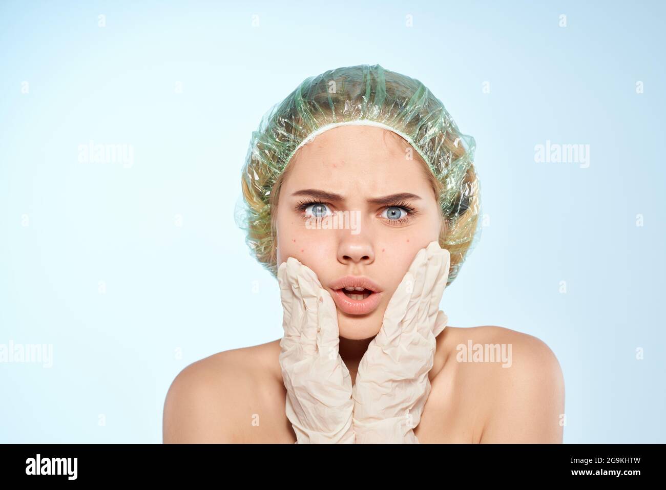 woman squeezes black dots on her face discontent blue background Stock ...
