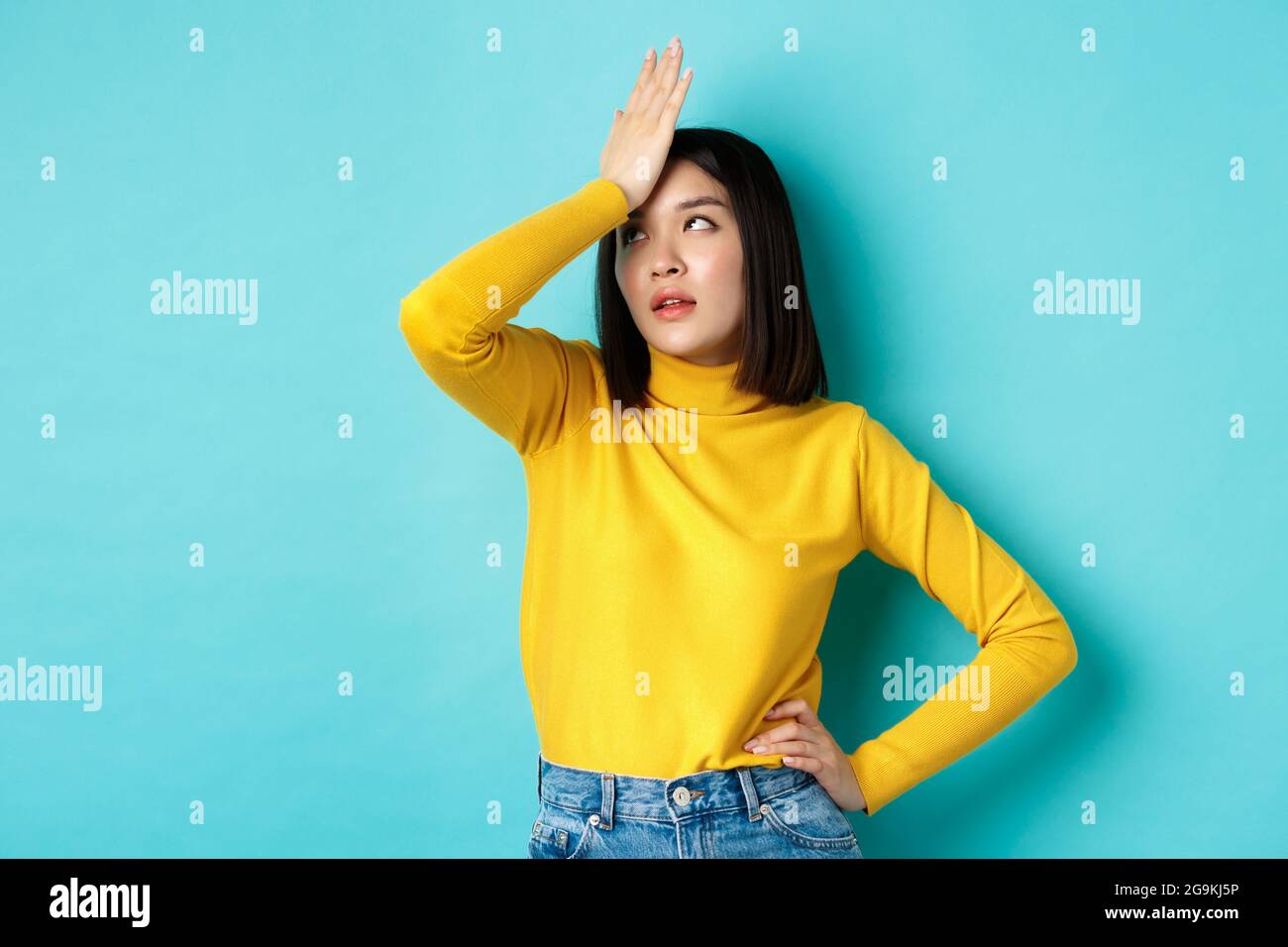 Emotions and lifestyle concept. Annoyed asian girl roll eyes and face ...