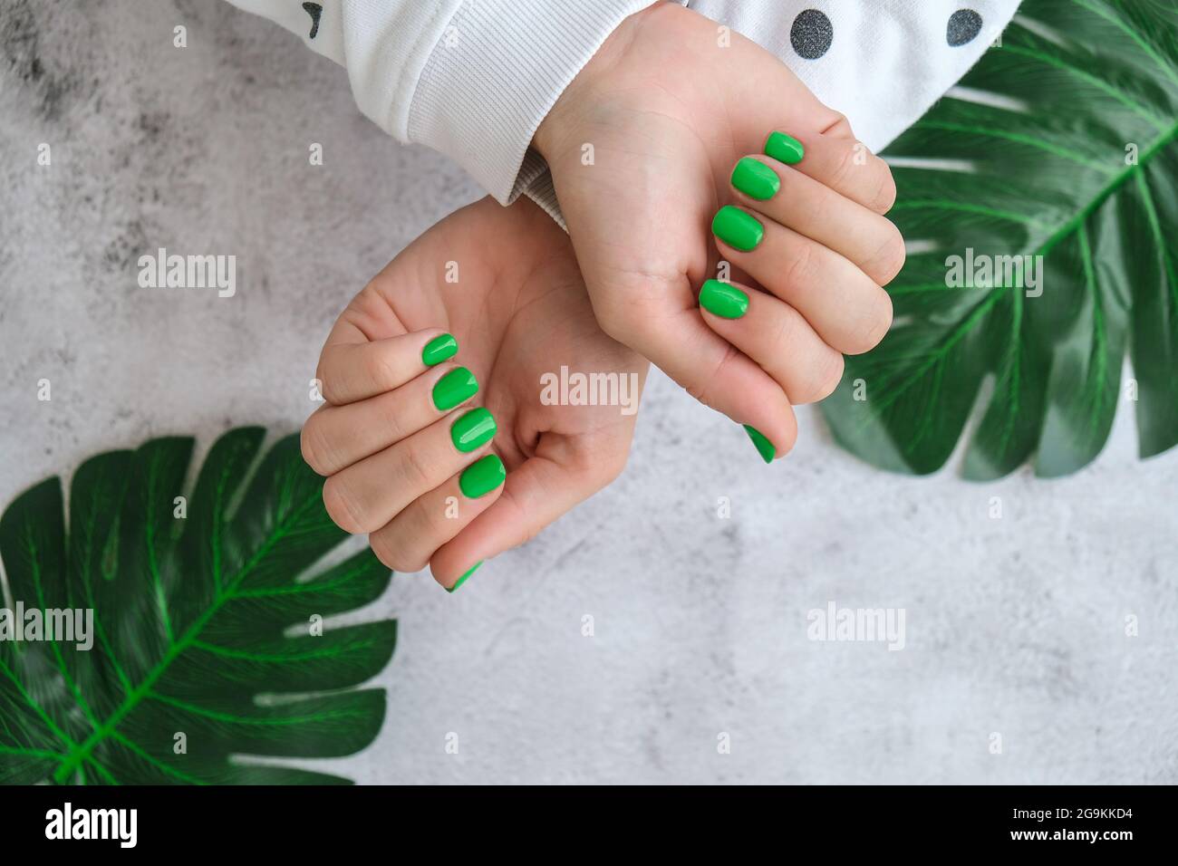 Manicured female hands with stylish green nails. Trendy modern design ...