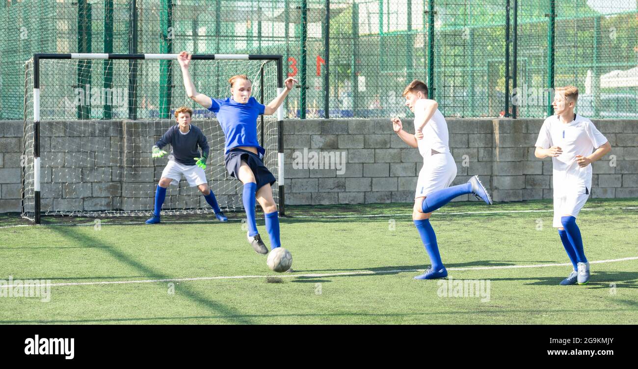 Teens playing soccer football match. Competition between two youth ...