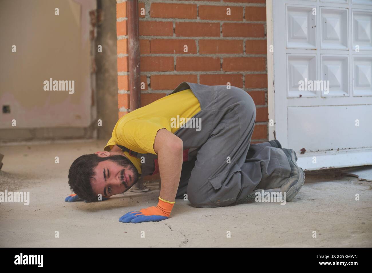 Young caucasian construction worker checking if the floor is level ...