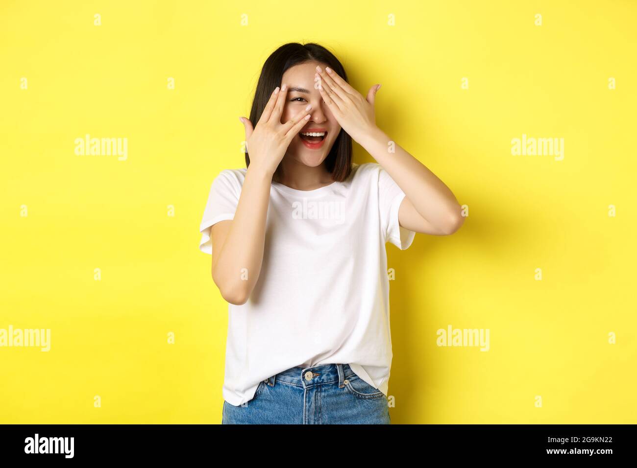 Hand over eyes peeking woman hi-res stock photography and images - Alamy