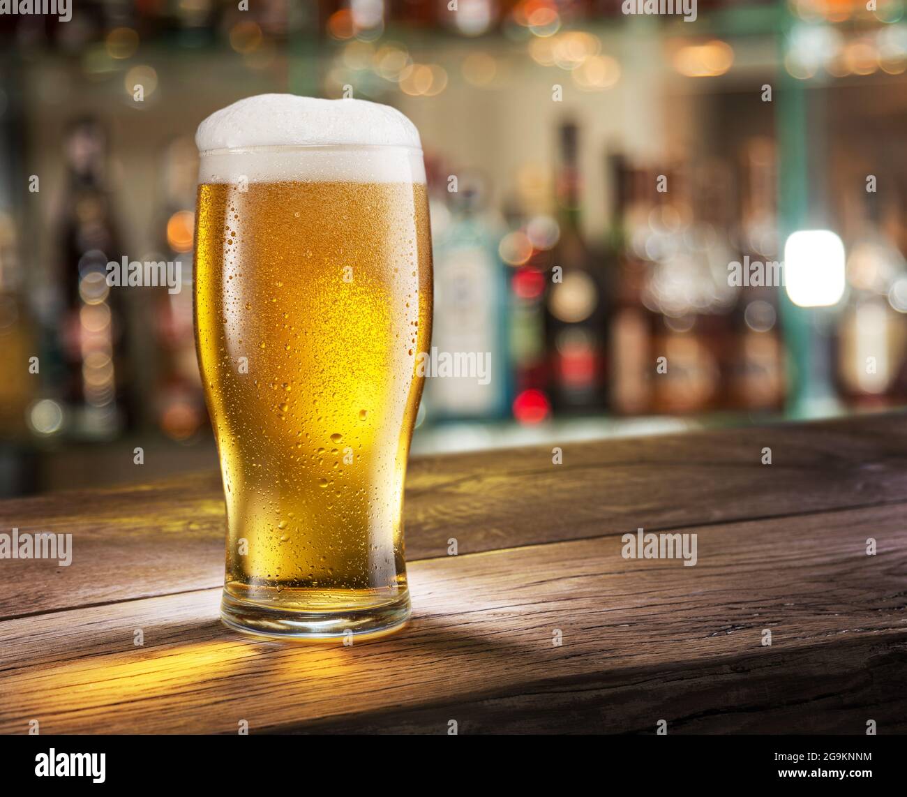 Cooled glass of pale beer with condensation drops on glass surface on ...
