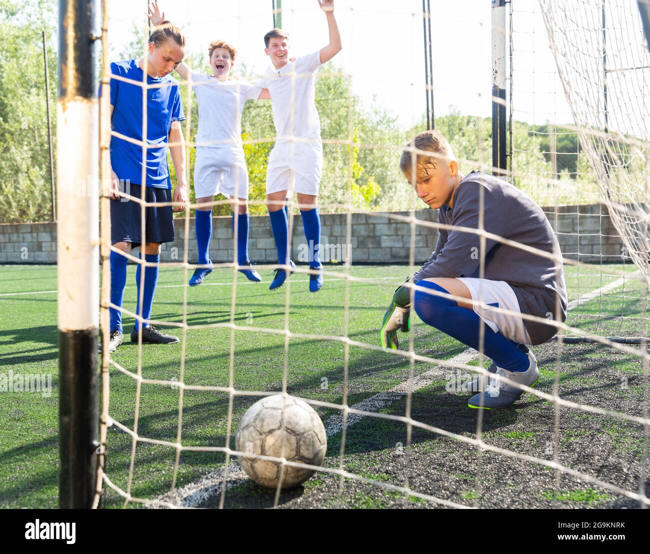 Upset goalkeeper looks at ball in goal. Football soccer tournament ...