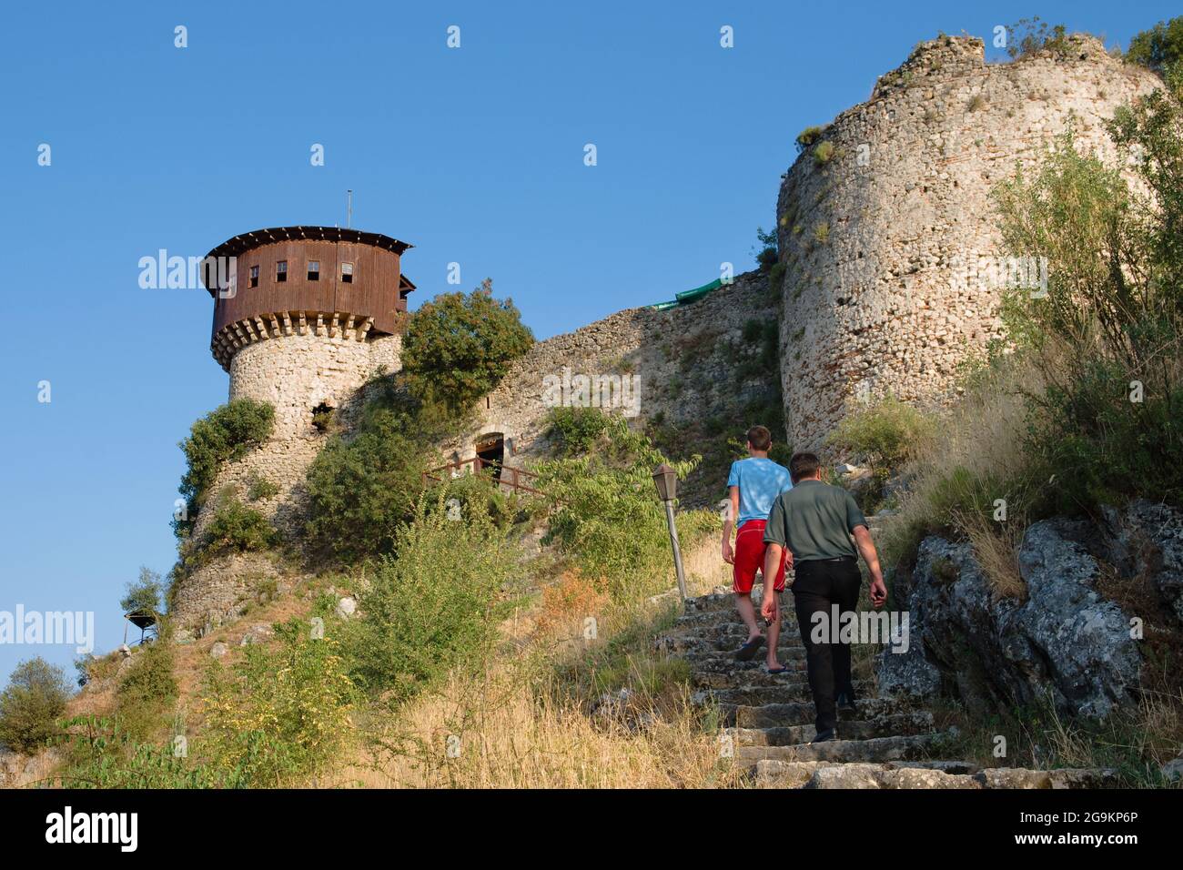 Petrele, Albania - July 22, 2012: two visitors go up the stairs that ...