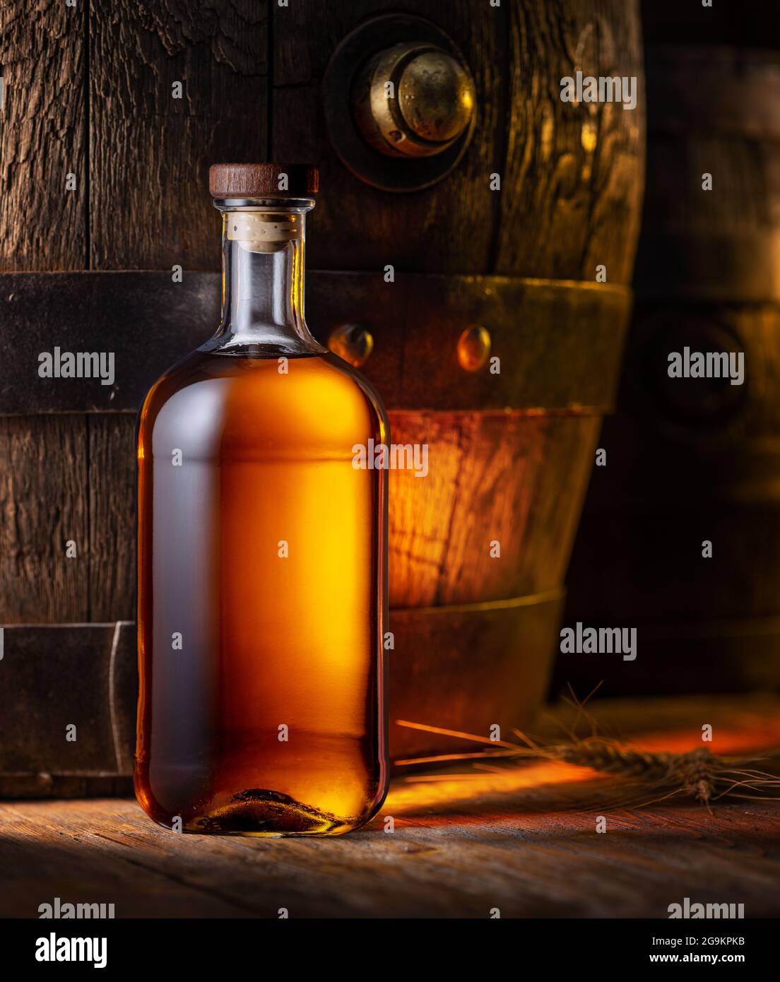 Bottle of whisky and old wooden cask at the background Stock Photo - Alamy