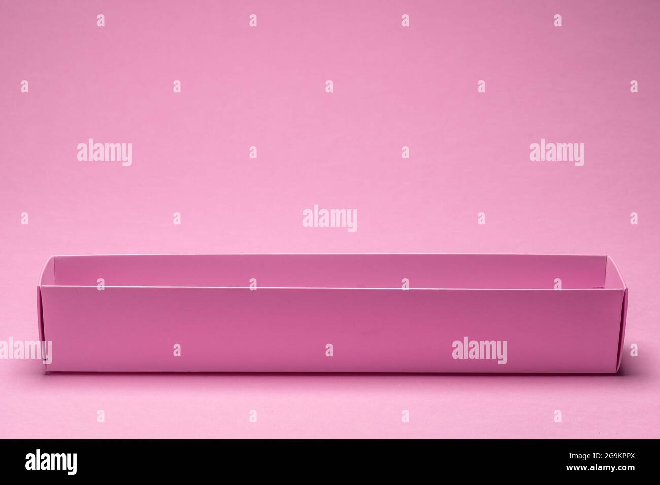 Empty open paper package box on pink background Stock Photo - Alamy