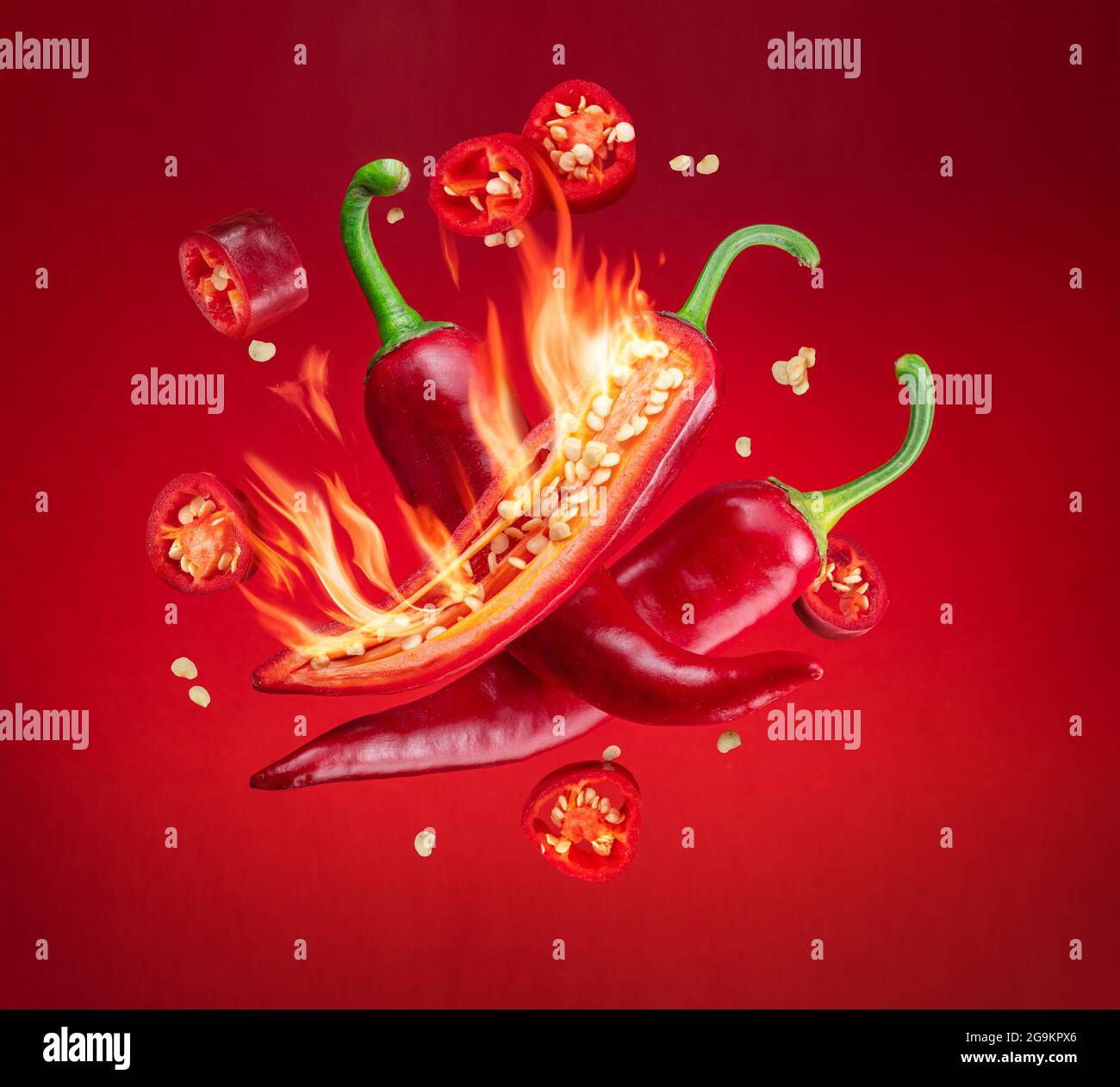 Fresh red chilli pepper in fire as a symbol of burning feeling of spicy ...