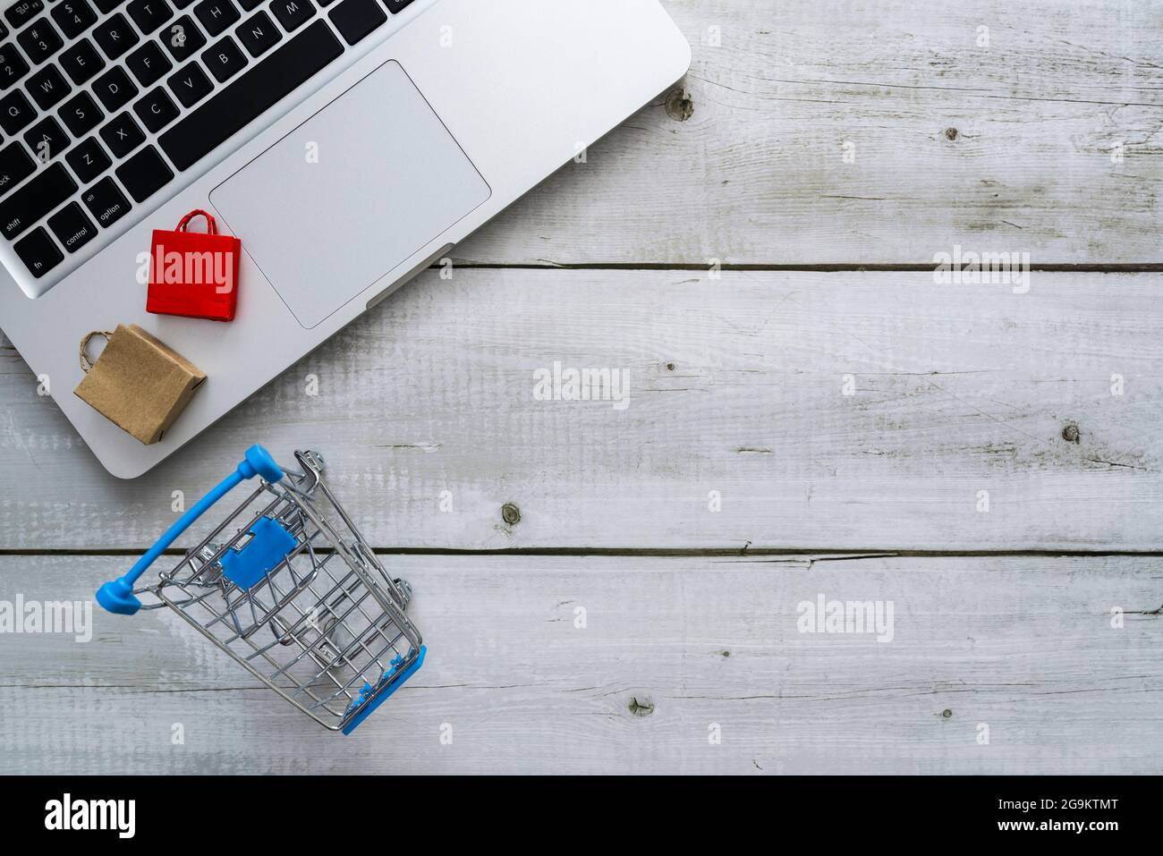 Flat lay online shopping concept with laptop, paper shopping bag and ...