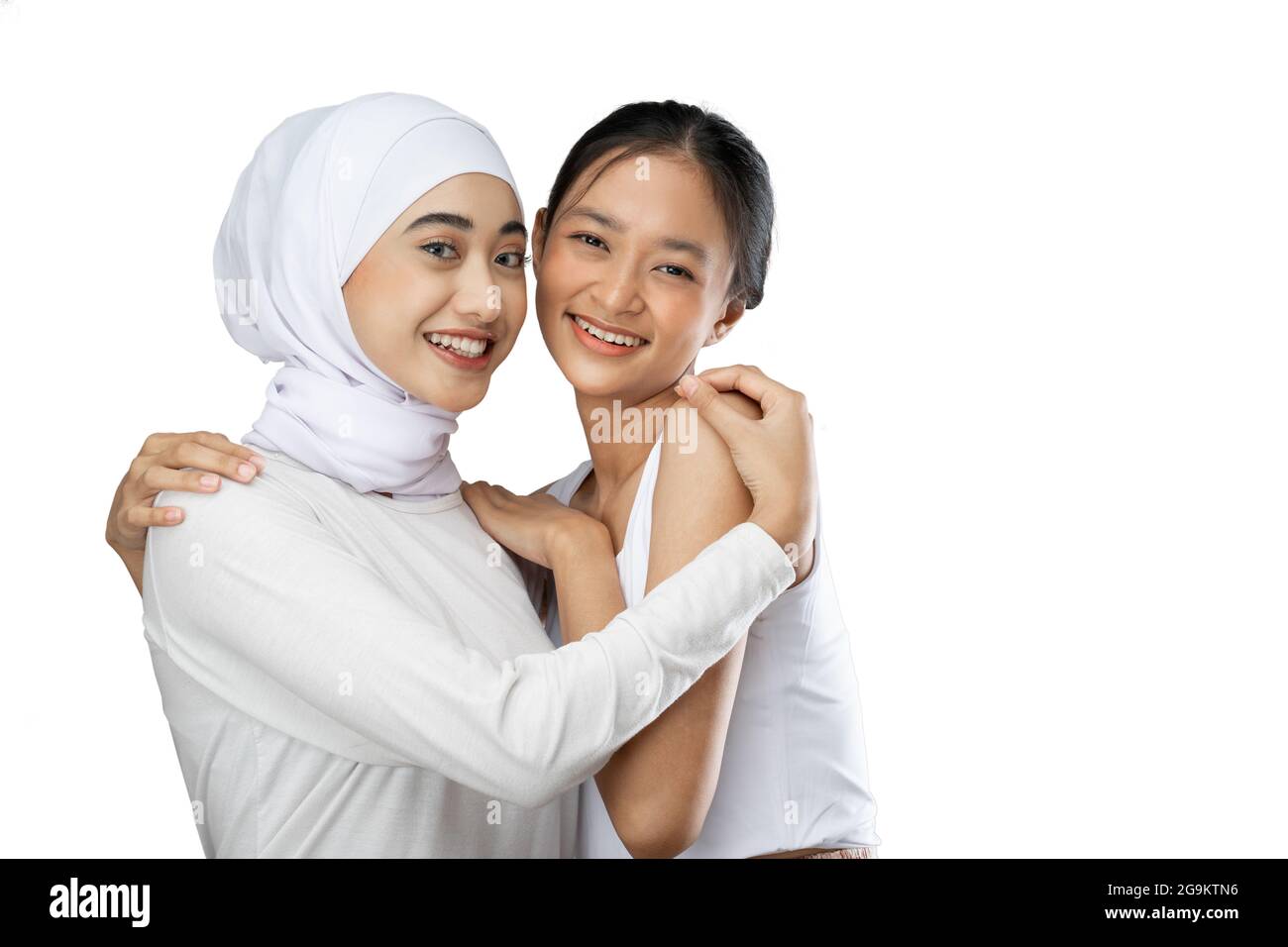 positive girls of different religion standing next to friendly ...